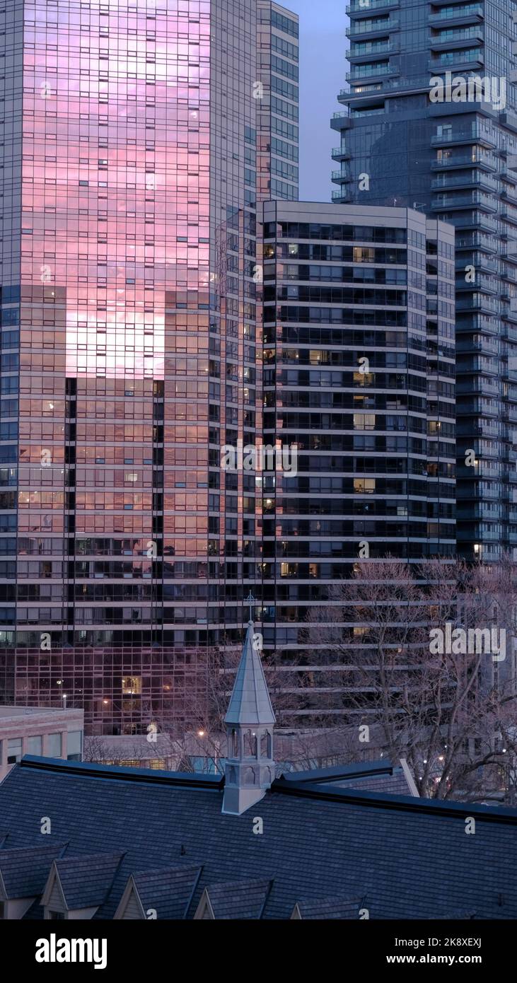 A vertical shot of beautiful skyscrapers and a small church tower Stock ...