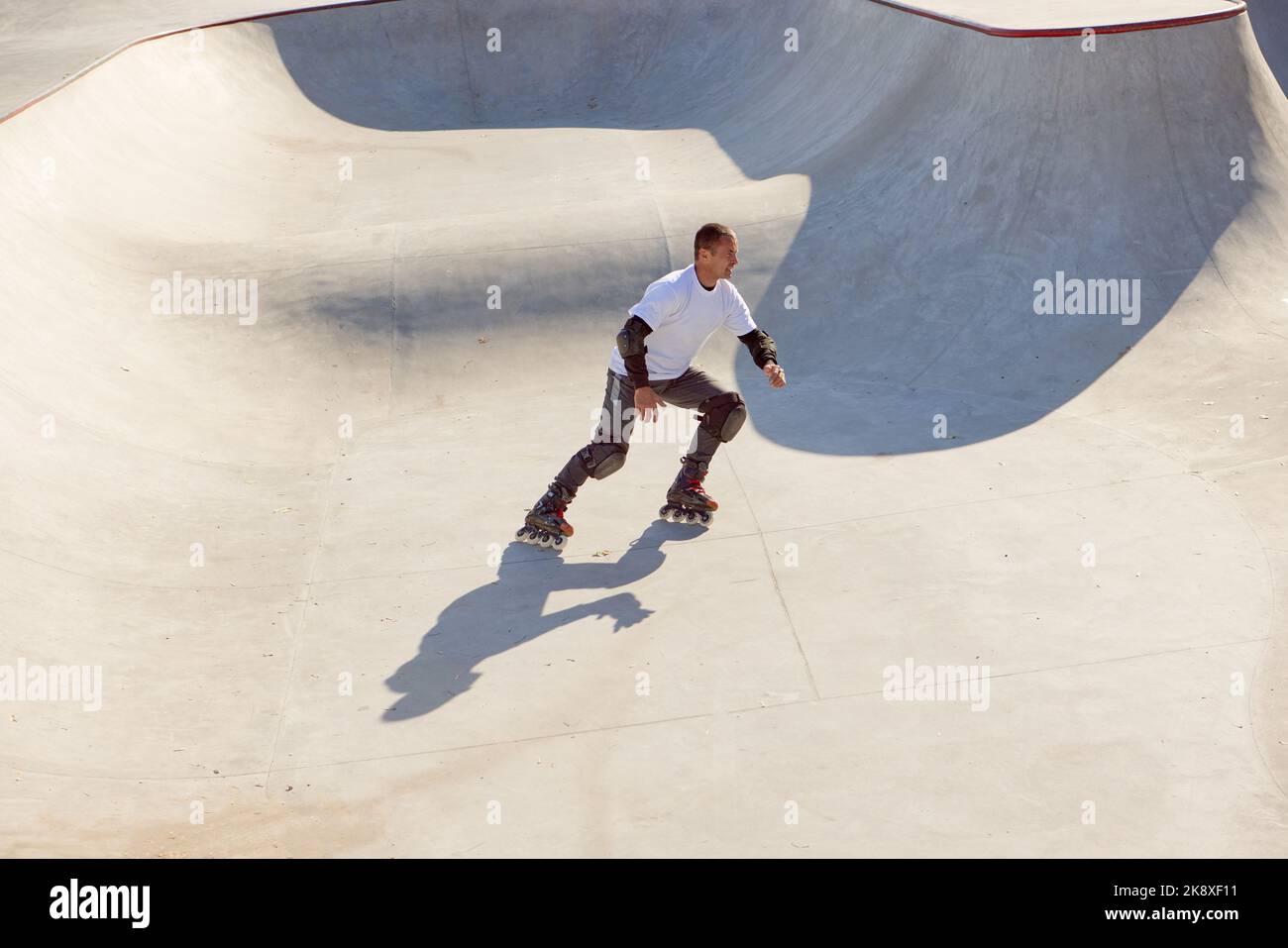 One man, male roller skater on rollerblades training at modern skate ...