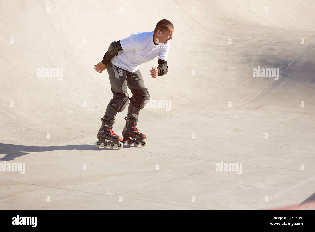 One man, male roller skater on rollerblades training at modern skate ...