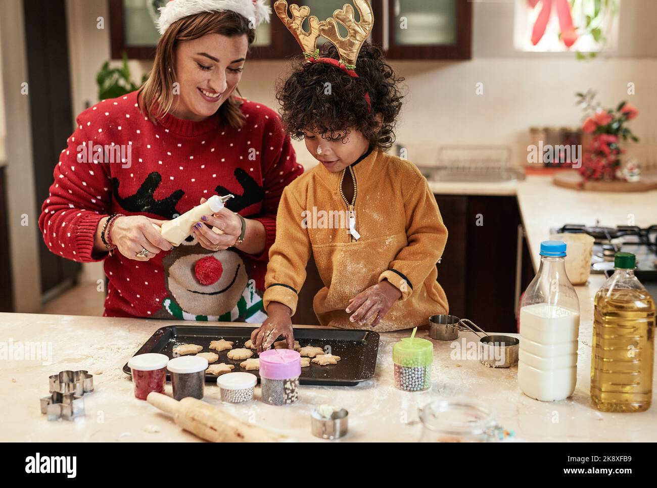This is the finishing touch. a cheerful young woman and her son baking ...