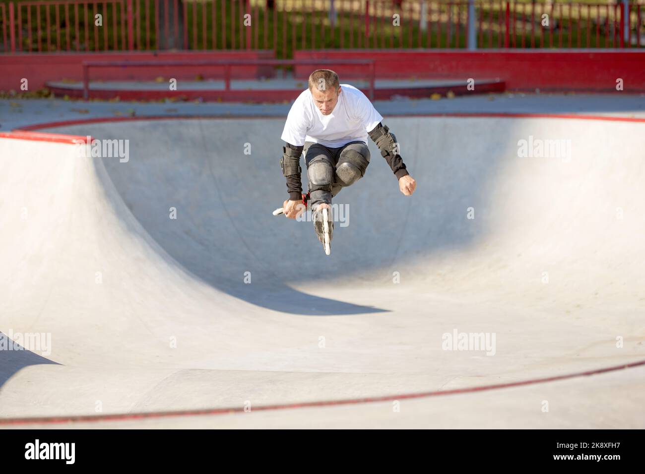 One man, male roller skater on rollerblades training at modern skate ...