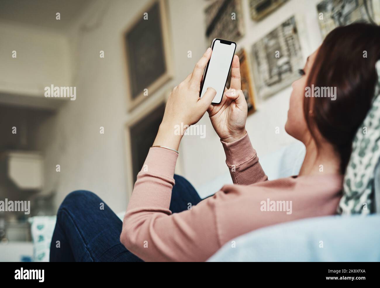 Kicking back and relaxing. an attractive young woman lying on her home ...