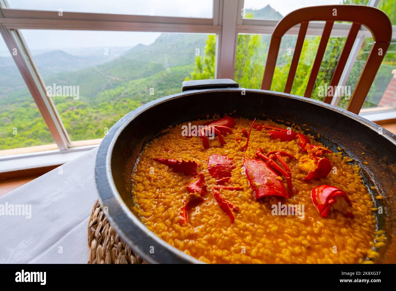 Traditional Spanish meal. Paella with a lobster. Tasty food from ...