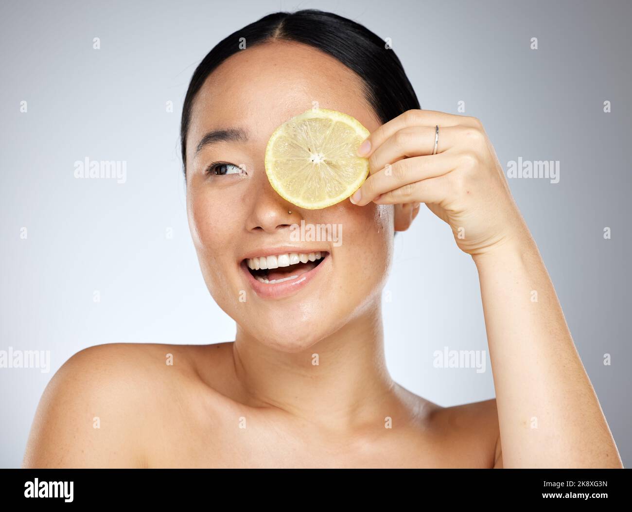 Portrait, happy and woman using lemon for facial skincare cleaning ...