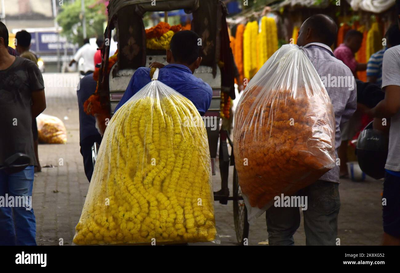 Guwahati, Guwahati, India. 24th Oct, 2022. Men carry flowers on the ...