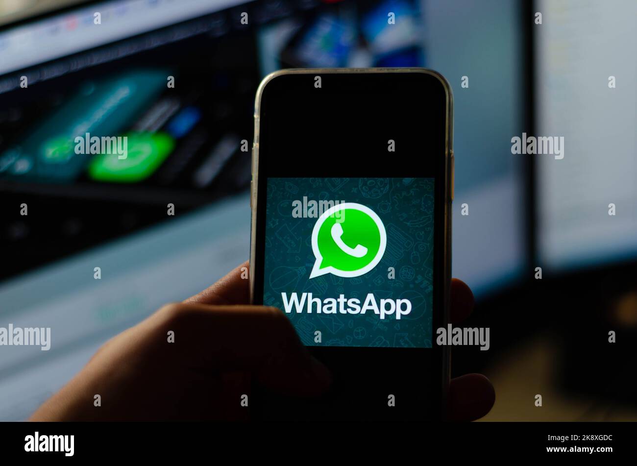 Hands Holding Mobile Smart Phone Device With Whatsapp Company App Logo ...