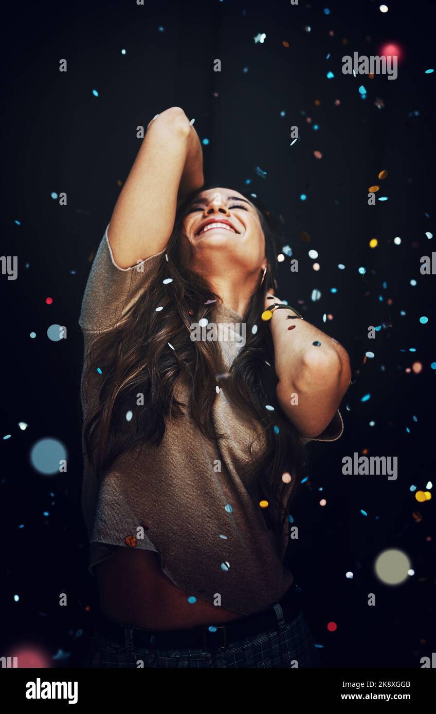Feeling the rhythm of the music. an attractive young woman dancing ...