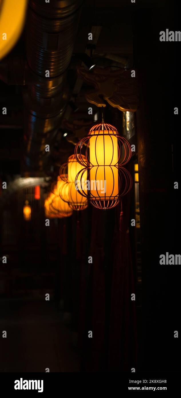 A hanging street lights on the road during nighttime Stock Photo - Alamy