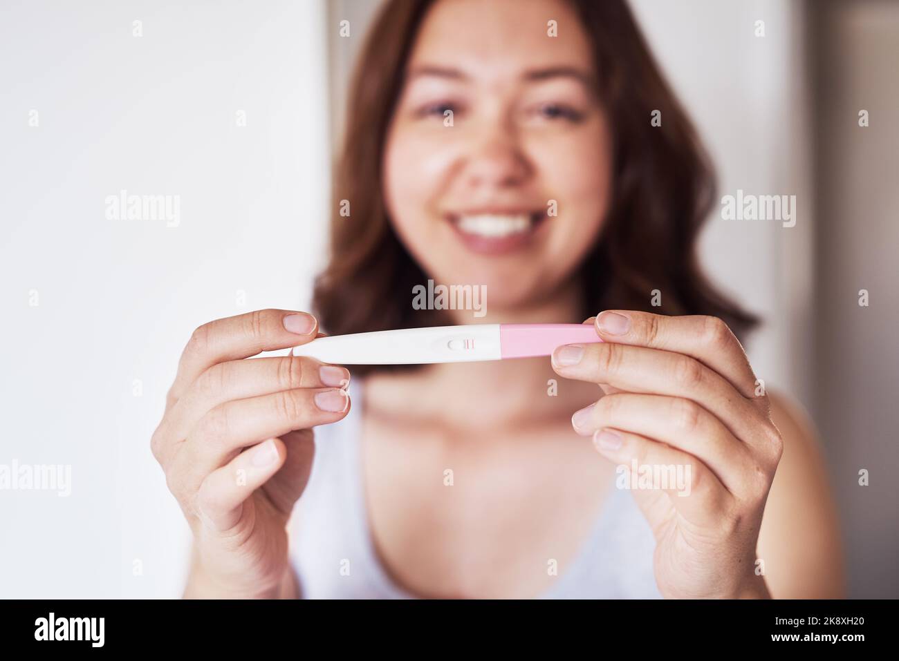 I have some good news to share. a young woman holding up a pregnancy ... I have some good news to share. a young woman holding up a pregnancy ...