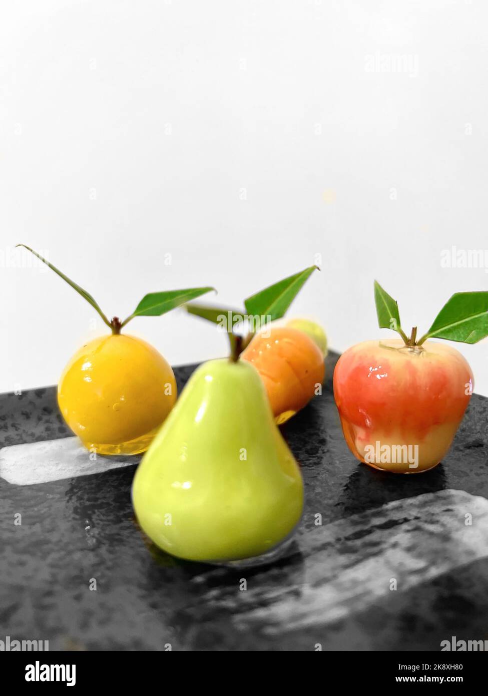 A vertical shot of fruits and vegetables cover by gelating against a ...