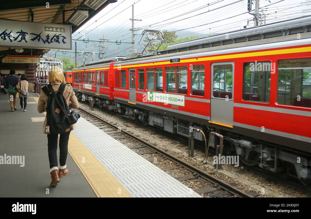 View of platform inside Hakone-Yumoto station with people walking and ...