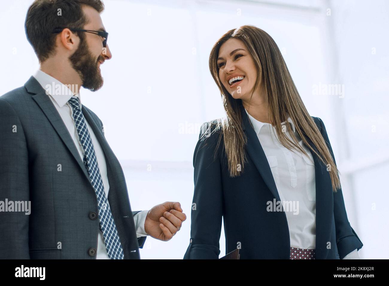 two employees talking standing in the office Stock Photo - Alamy