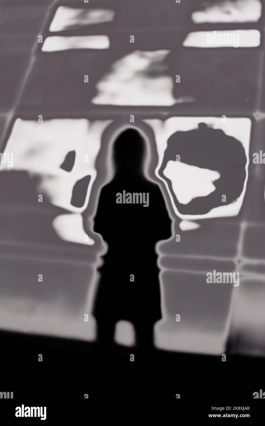 Creative black and white paranormal image of being in black silhouette ...