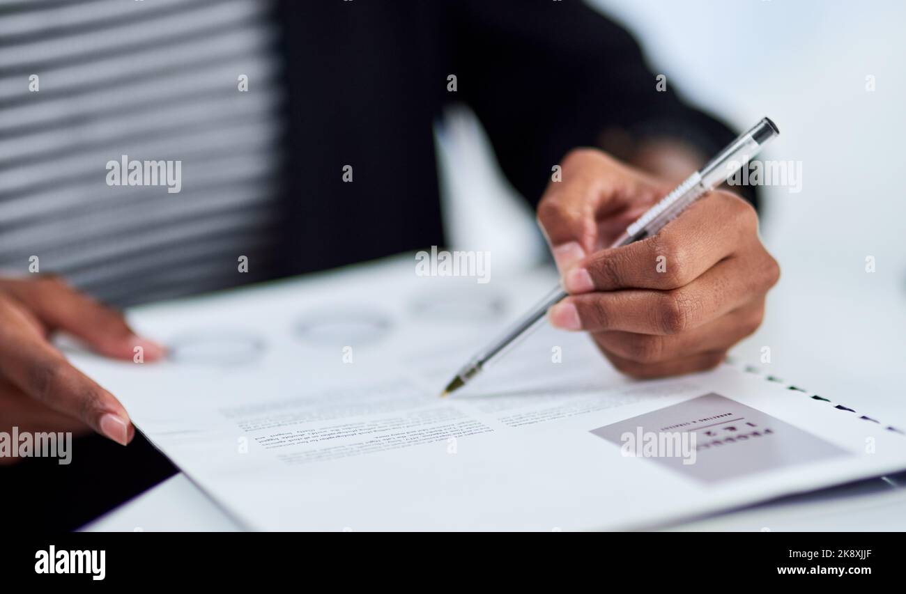 Going over some paperwork at the office. an unrecognizable ...