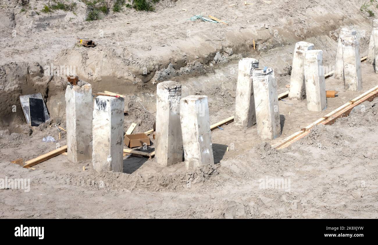 Concrete piles foundation for a new building on construction site ...