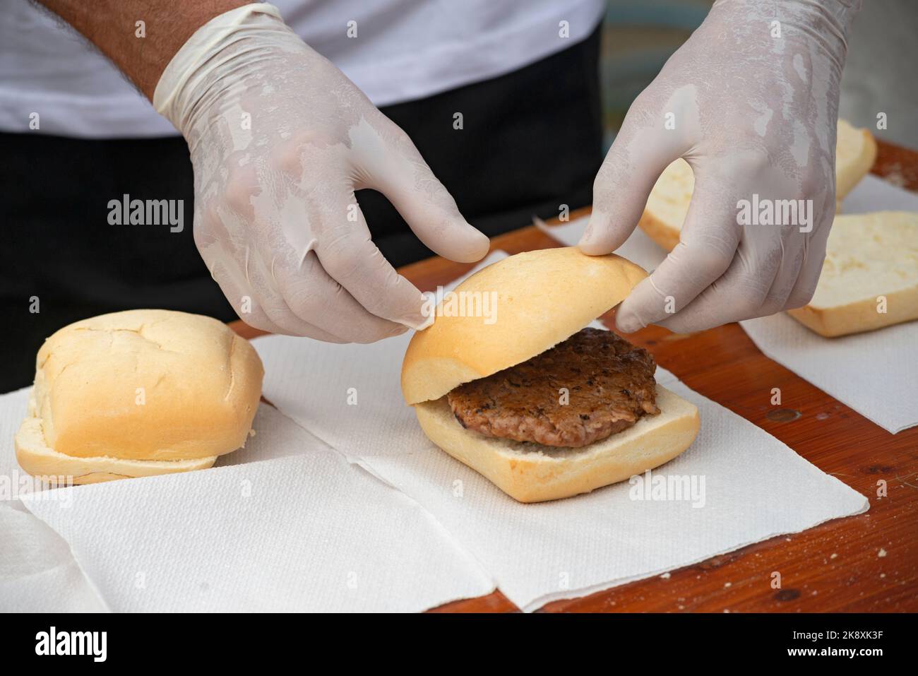 Italy, Lombardy, Street Food, Hand of a Chef Holding a Sausage Stock ...