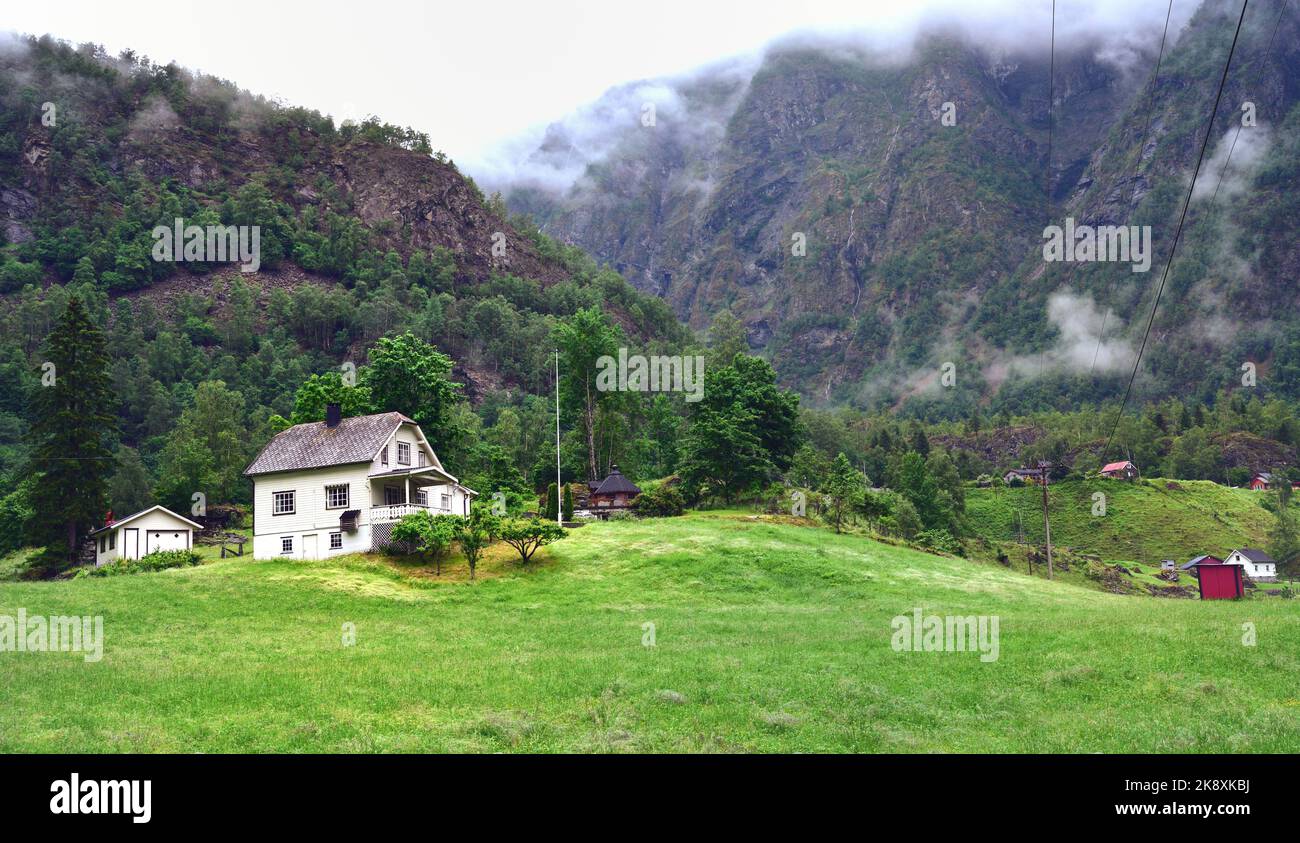 Traditional farmhouse in the misty fjord valley of the Breheimen ...