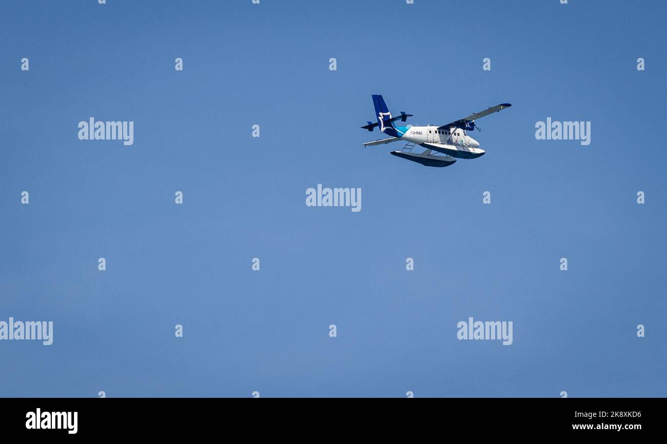 A trans Maldivian airplane flying in sky Stock Photo - Alamy