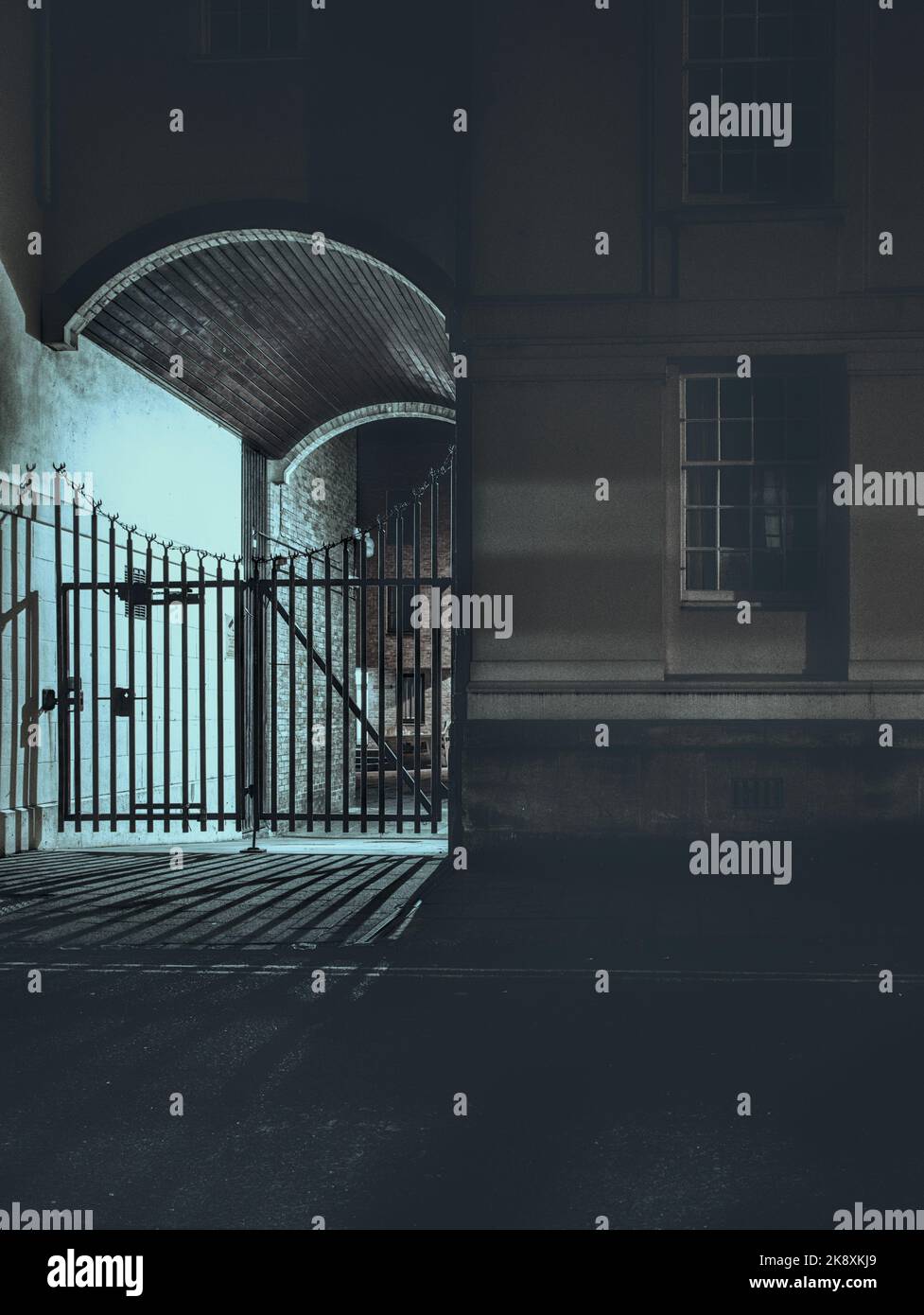 Light shining through iron gates in Oxford city centre after dark ...