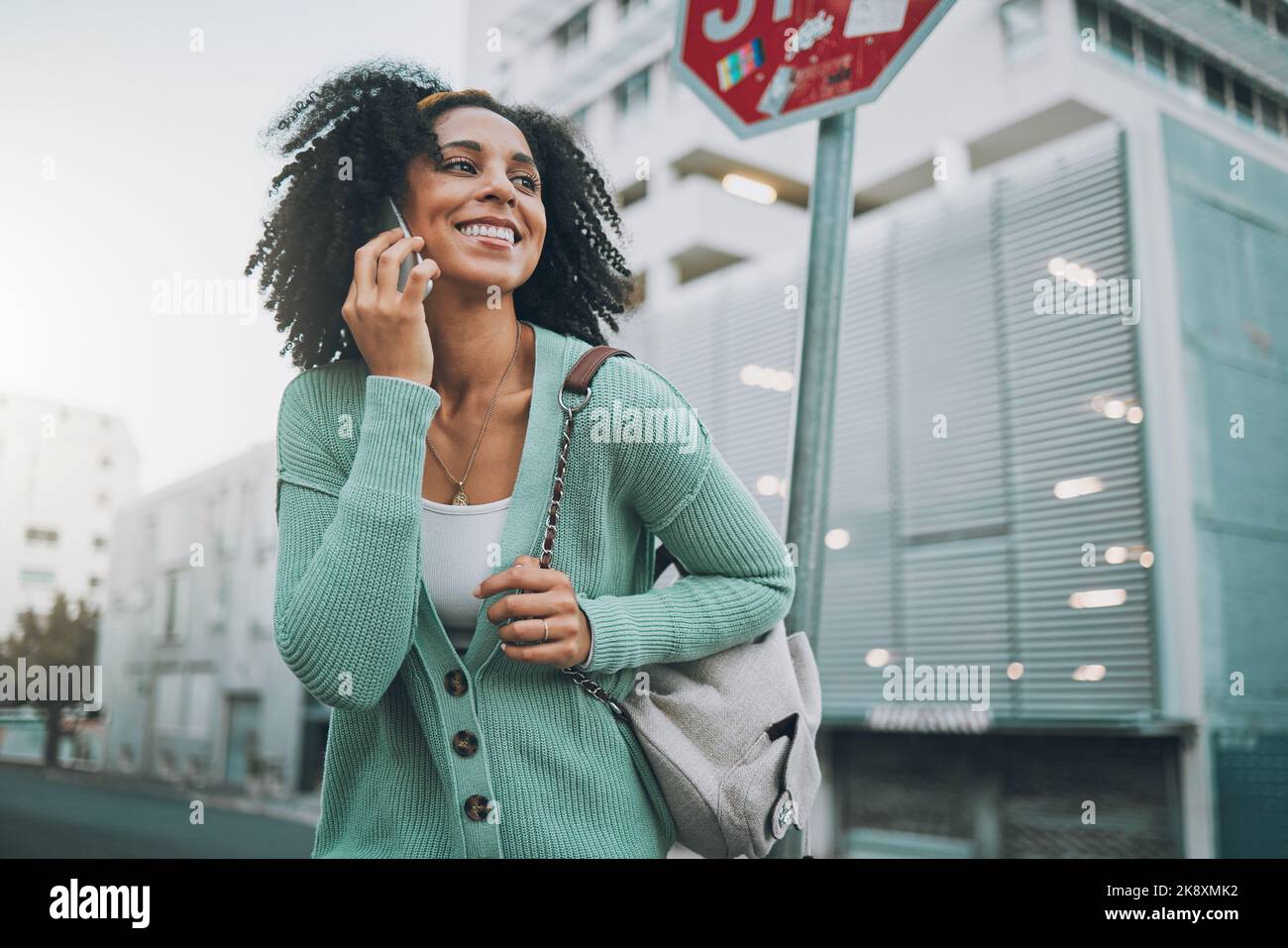 Black woman, phone call and smile in street, city or town for travel ...