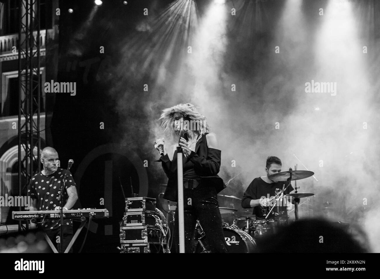 A grayscale closeup shot of singer Bori Peterfy during a concert with a ...