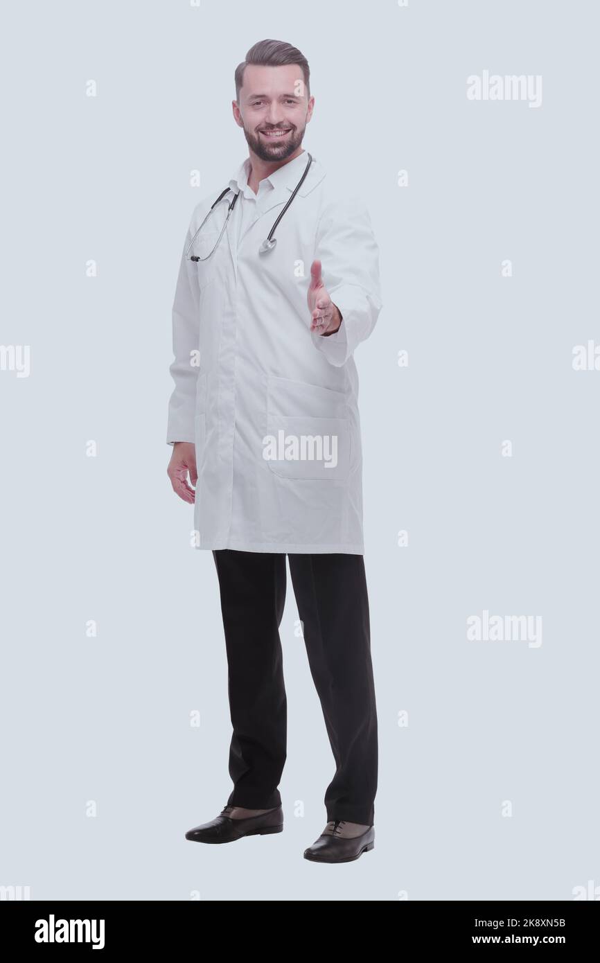 in full growth. the medical doctor holding out his hand for a handshake ...