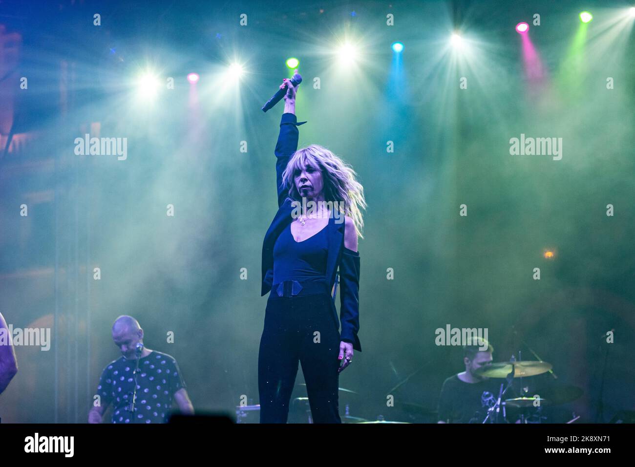 A closeup shot of singer Bori Peterfy during a concert with a band in ...