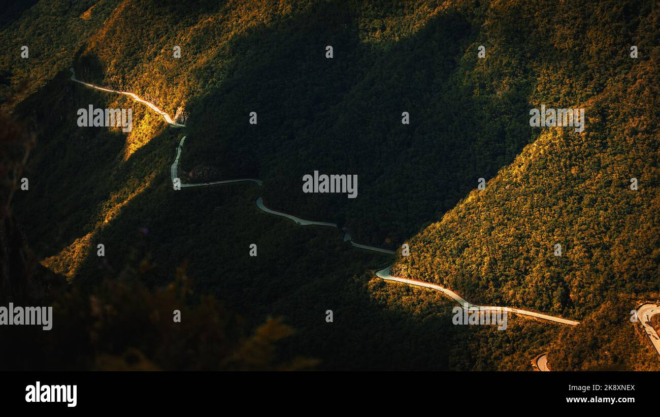 A narrow road going along the slope of mountain range Stock Photo - Alamy