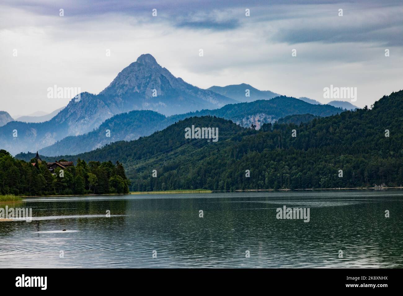 A beautiful scenery of a lake with mountains and cloudy sky Stock Photo ...