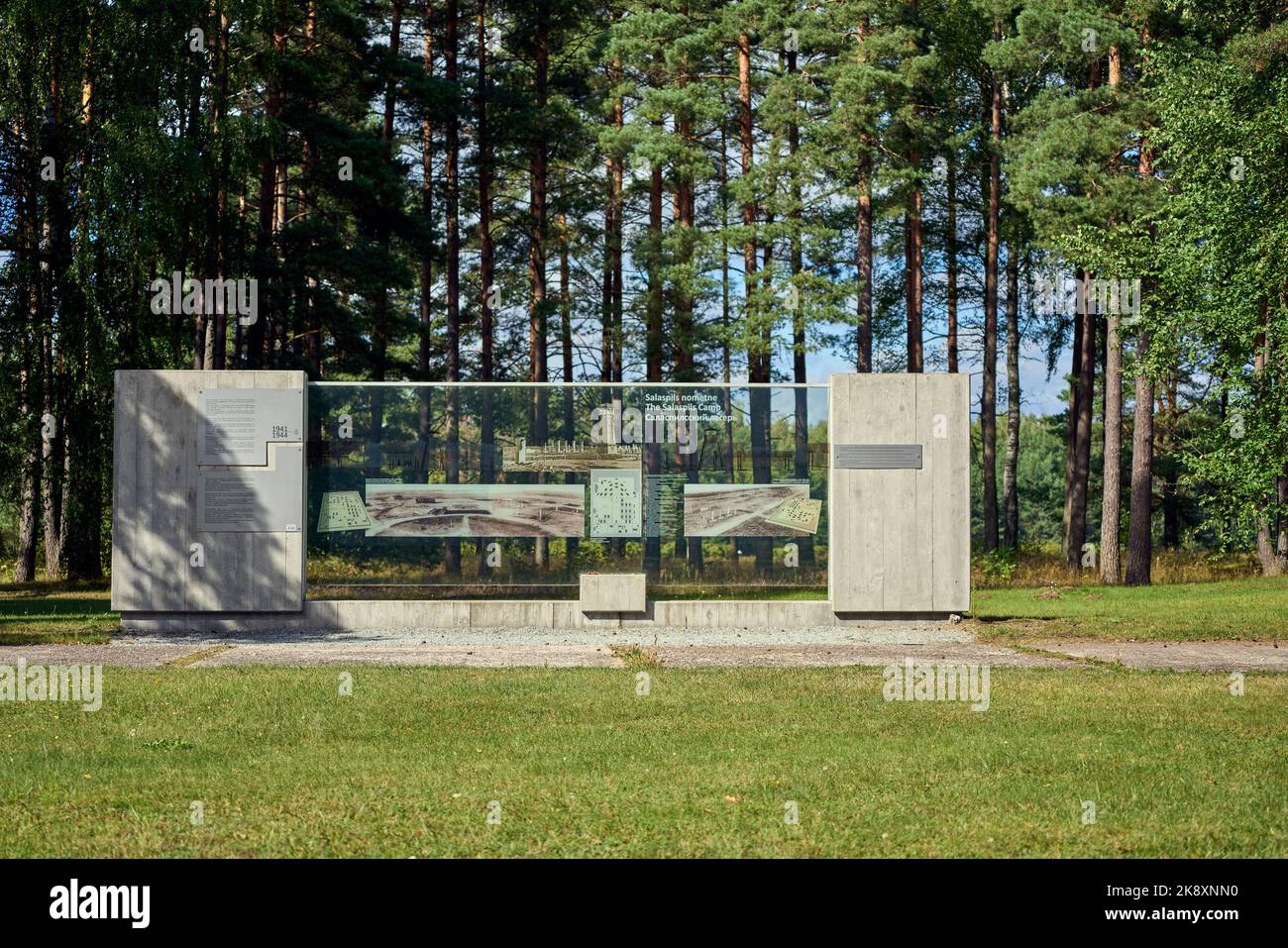 A glass board with pictures and text in Salaspils memorials of somber ...