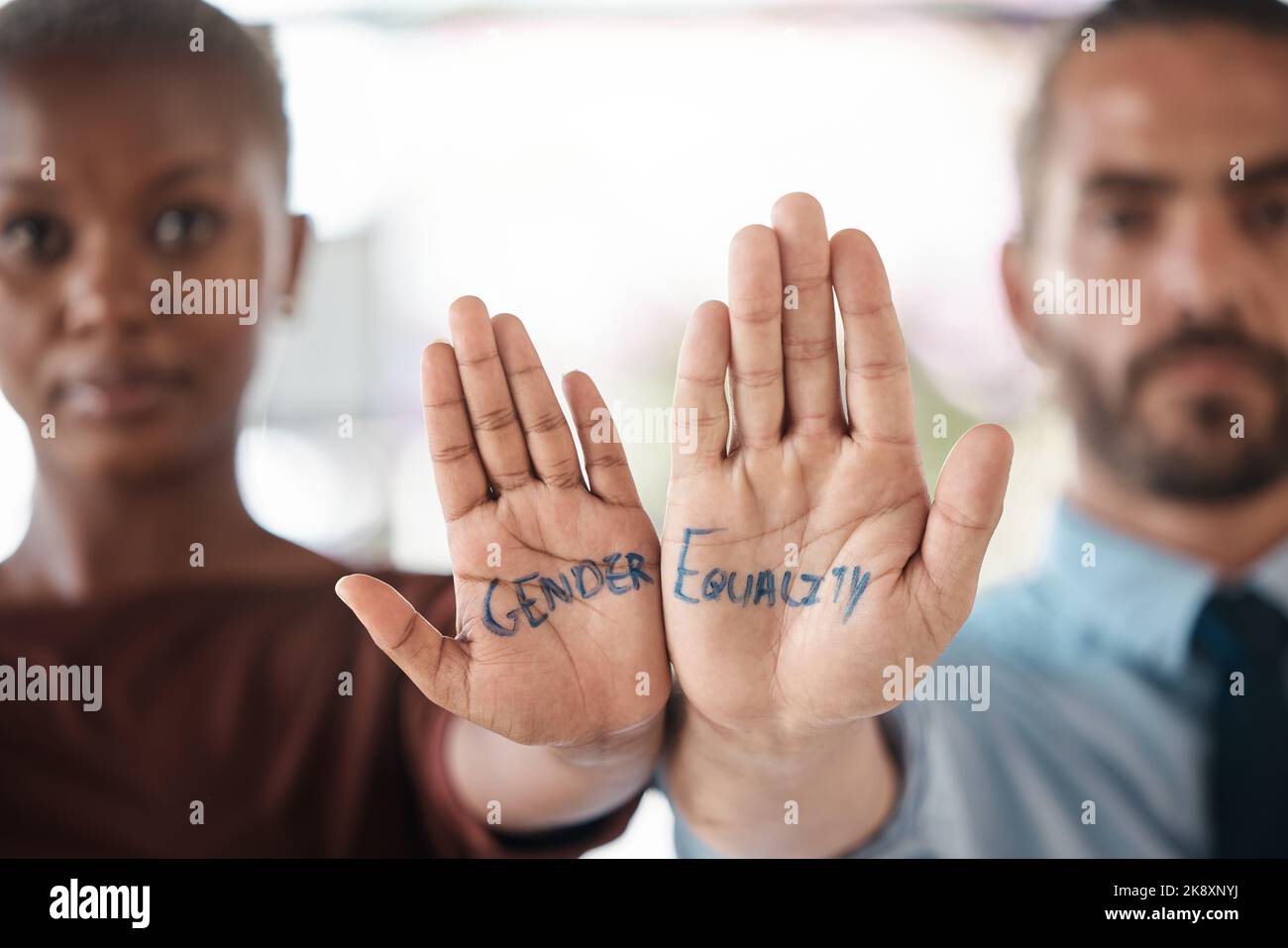Hands, gender equality and unity with a sign message on the hand of a ...