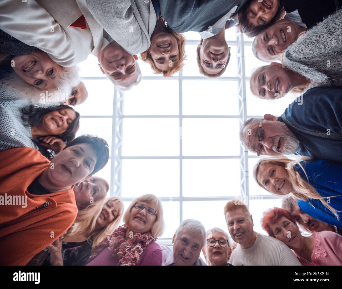 Happy people looking down at camera Stock Photo - Alamy