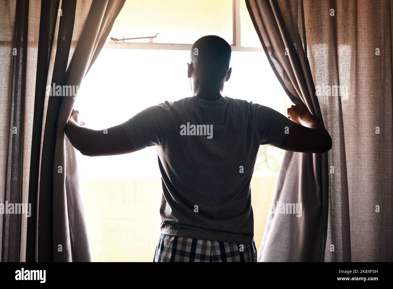 Man opening curtains in the morning hi-res stock photography and images ...