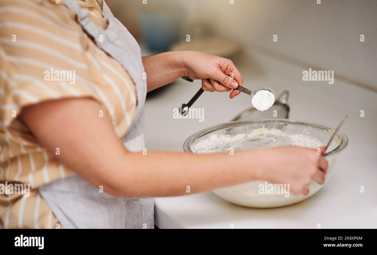 This will make it fluffy and big. an unrecognizable woman adding baking ...