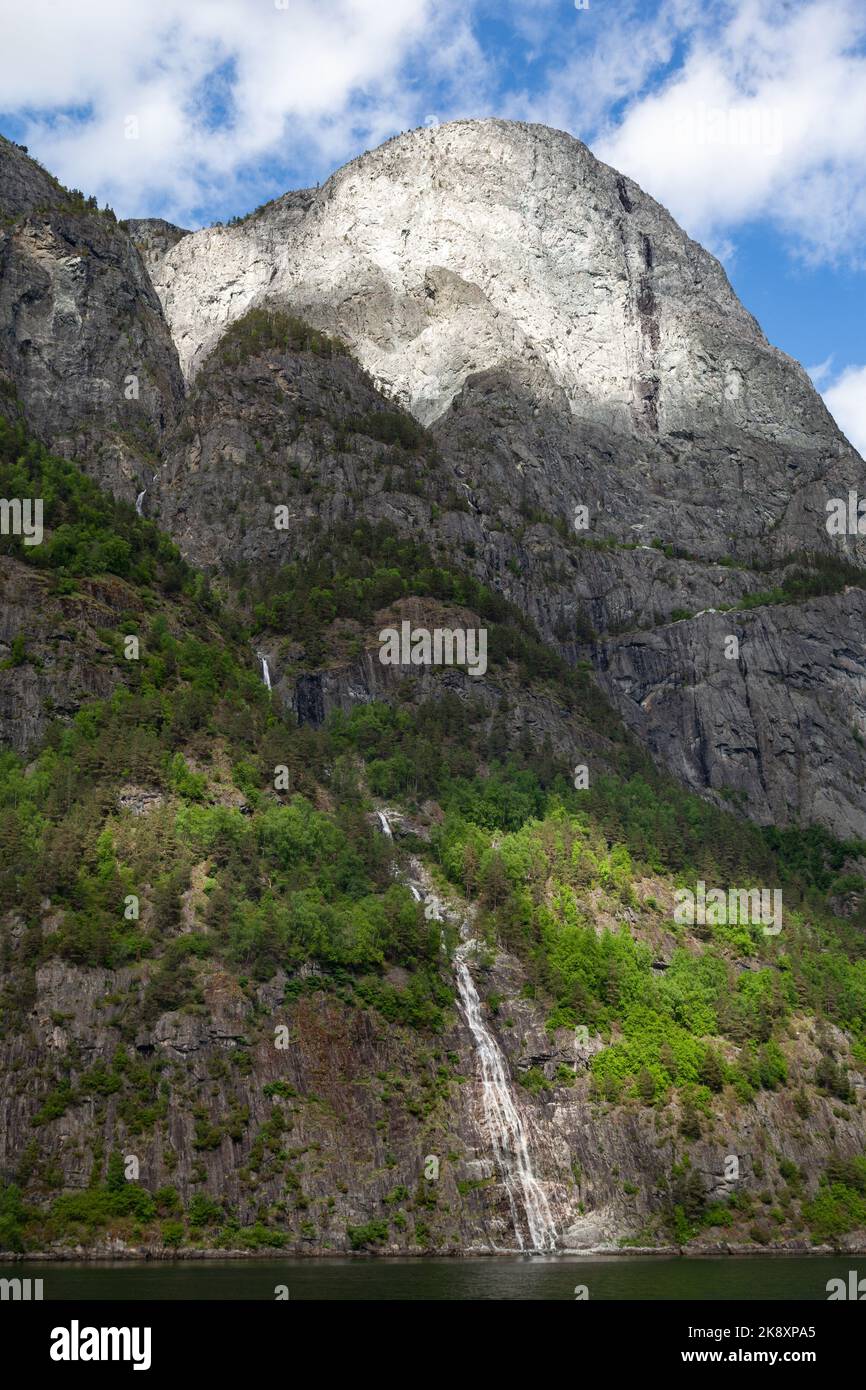 A vertical shot of Narrow Fjord surrounded by mountains with a ...