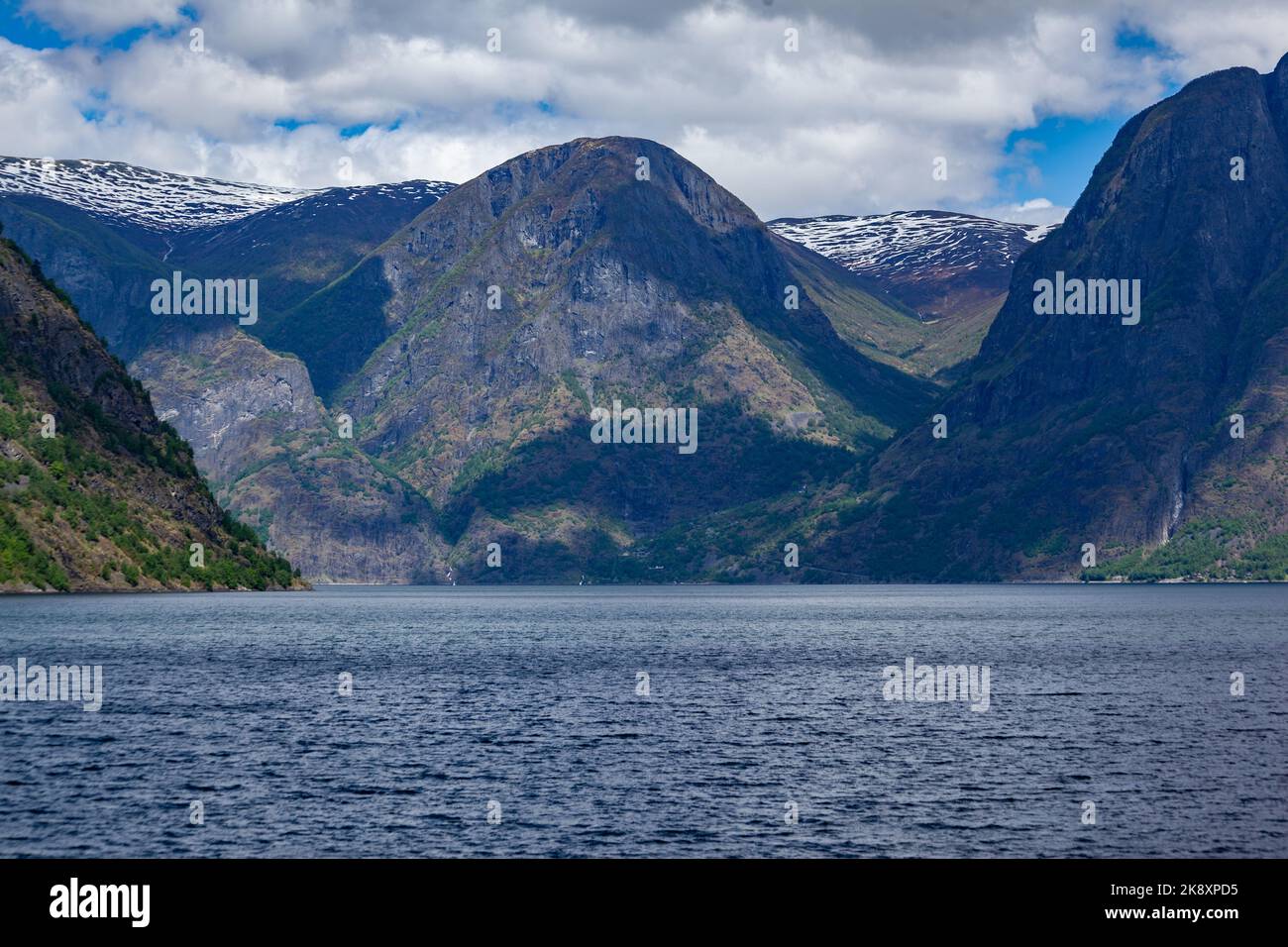 A Narrow Fjord surrounded by mountains covered with trees in Vestland ...