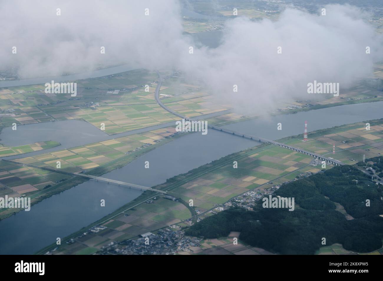 An aerial shot from the aircraft over the Japanese fields and a river ...
