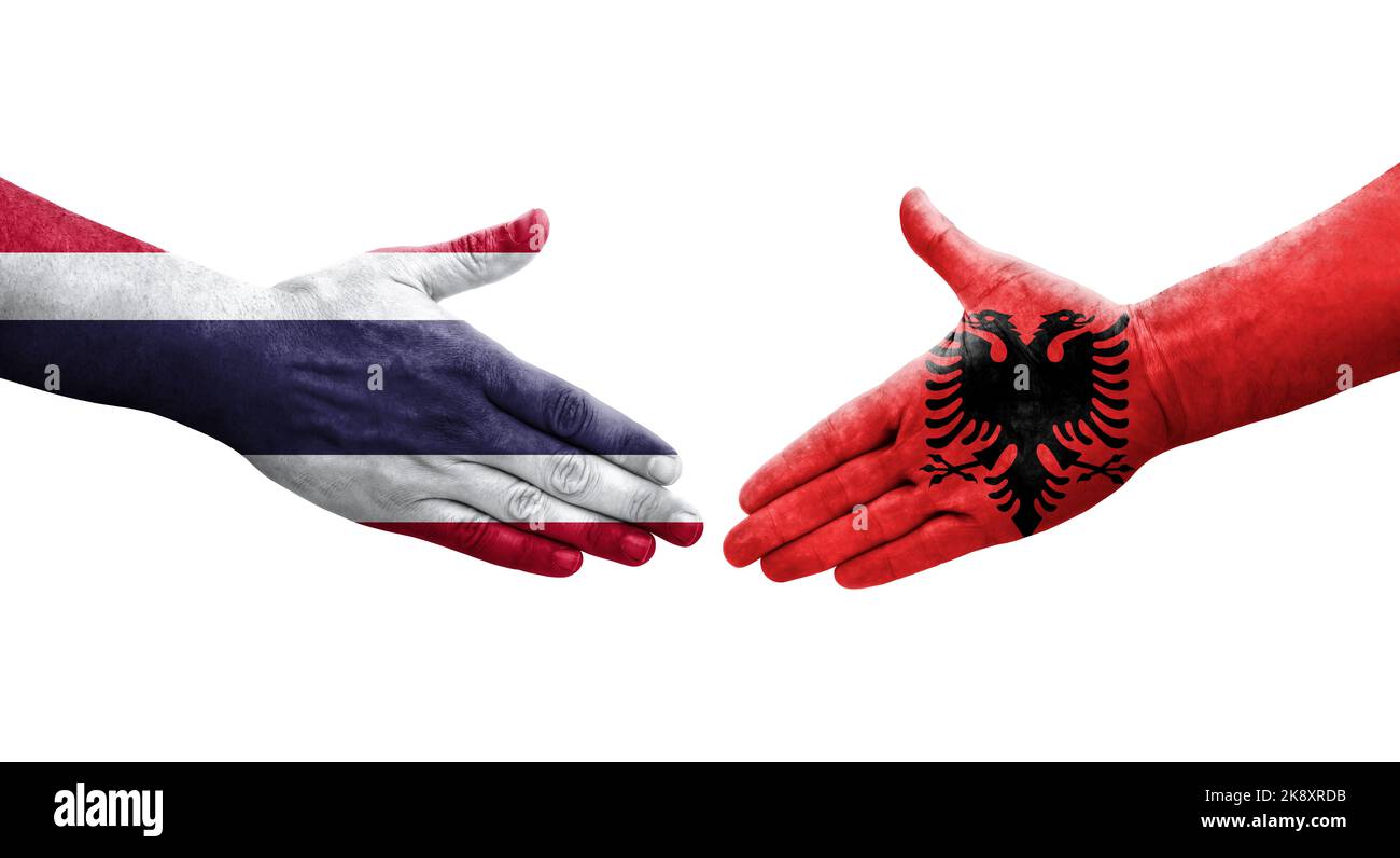 Handshake between Albania and Thailand flags painted on hands, isolated ...