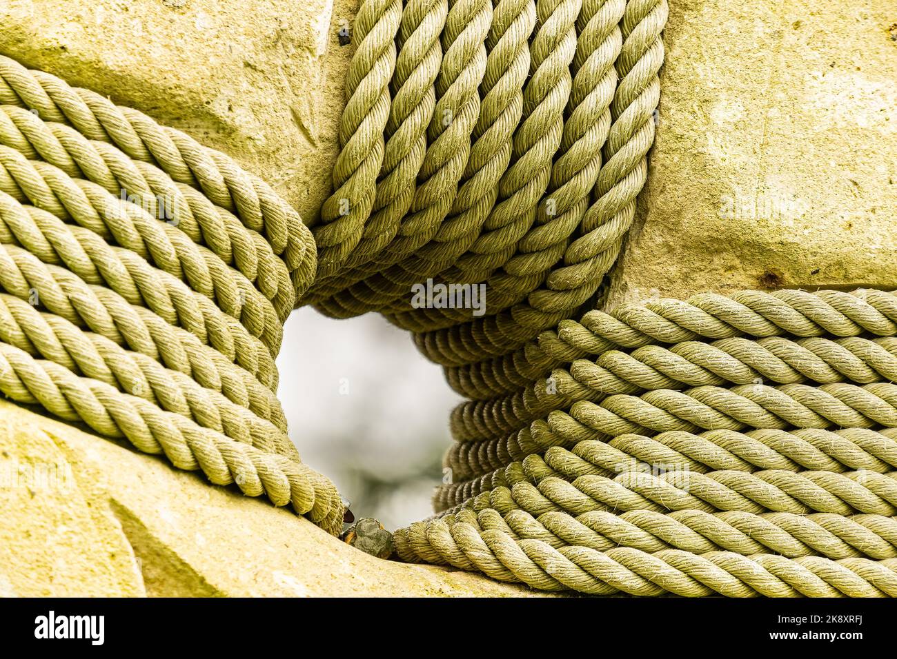 A closeup of stony sculpture bound with ropes Stock Photo - Alamy
