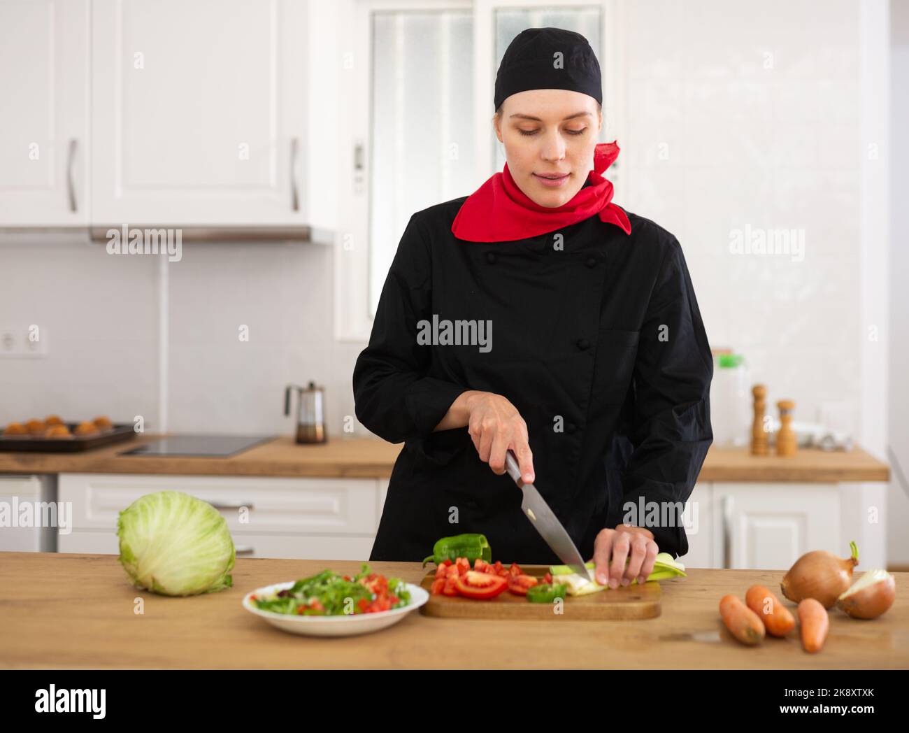 Female chef preparing vegetable salad, cutting vegetables Stock Photo ...