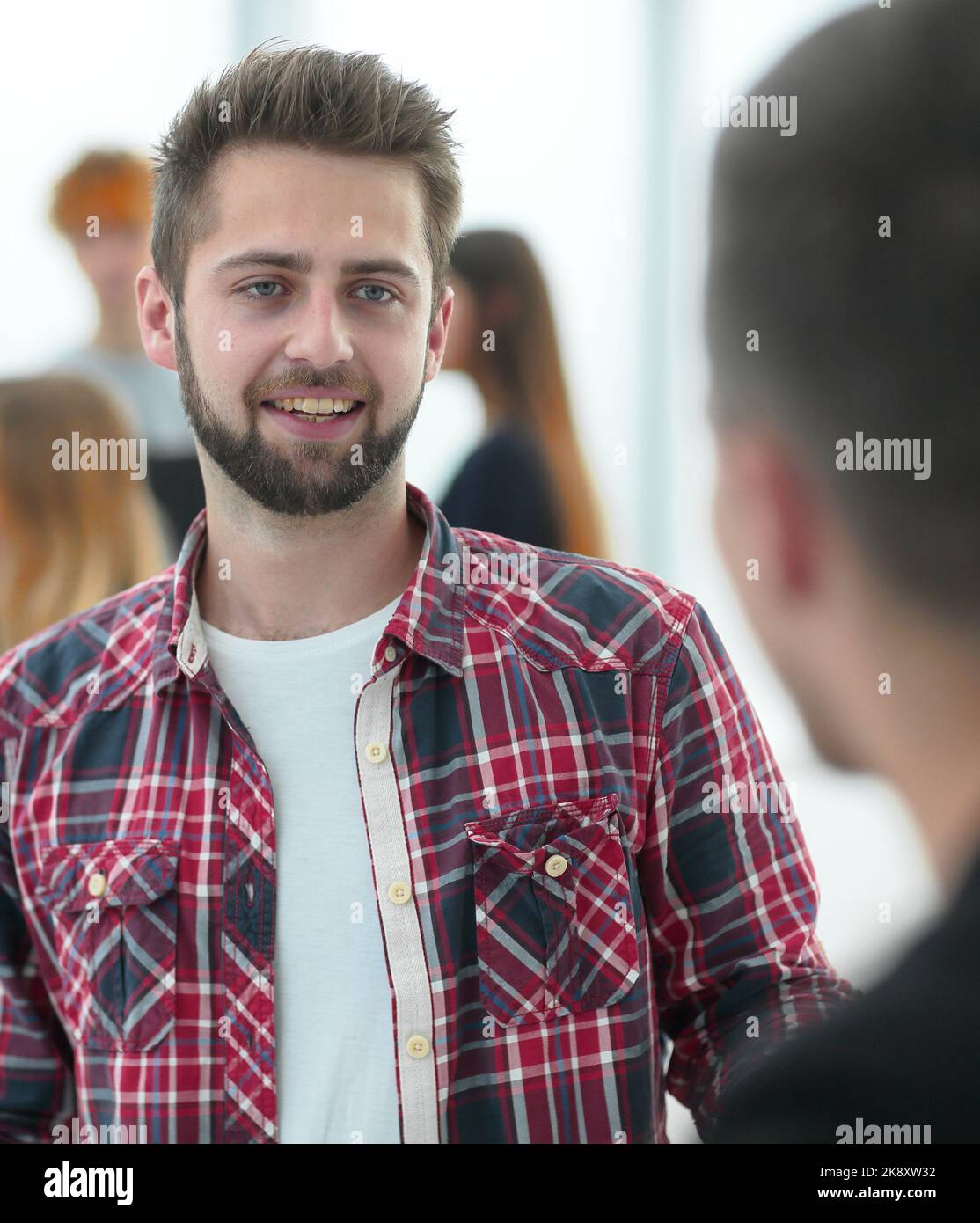 close up. young employee standing among his colleagues Stock Photo - Alamy