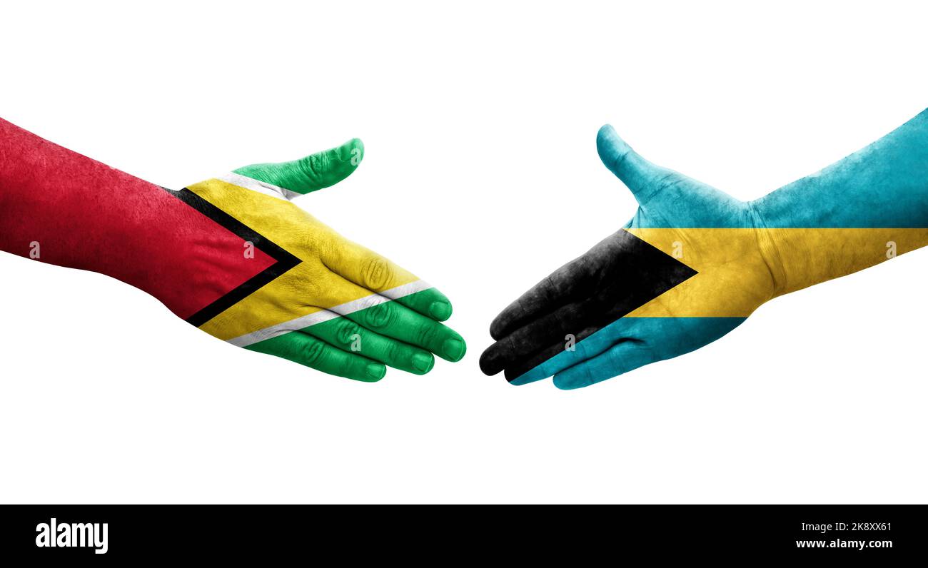 Handshake between Bahamas and Guyana flags painted on hands, isolated ...