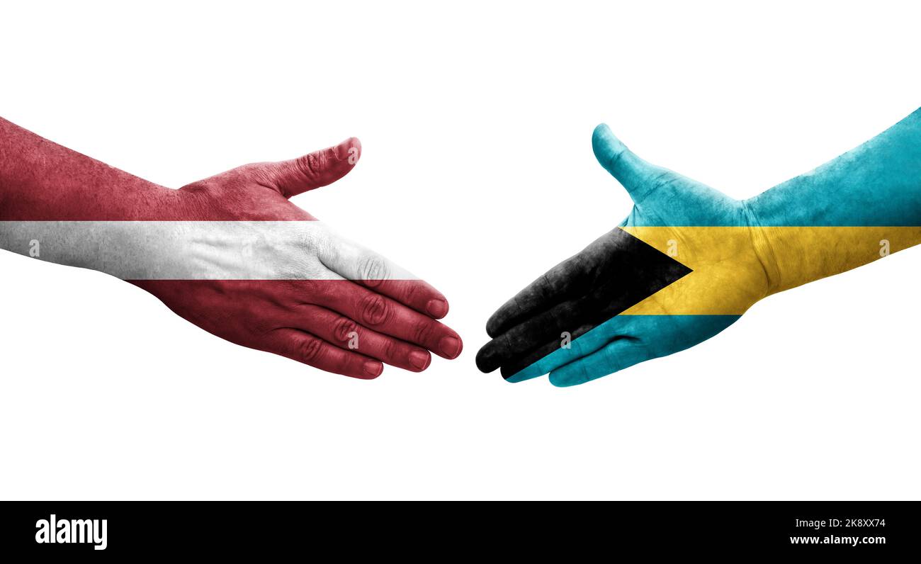 Handshake between Bahamas and Latvia flags painted on hands, isolated ...
