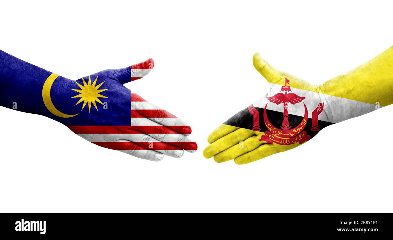 Handshake between Brunei and Malaysia flags painted on hands, isolated ...