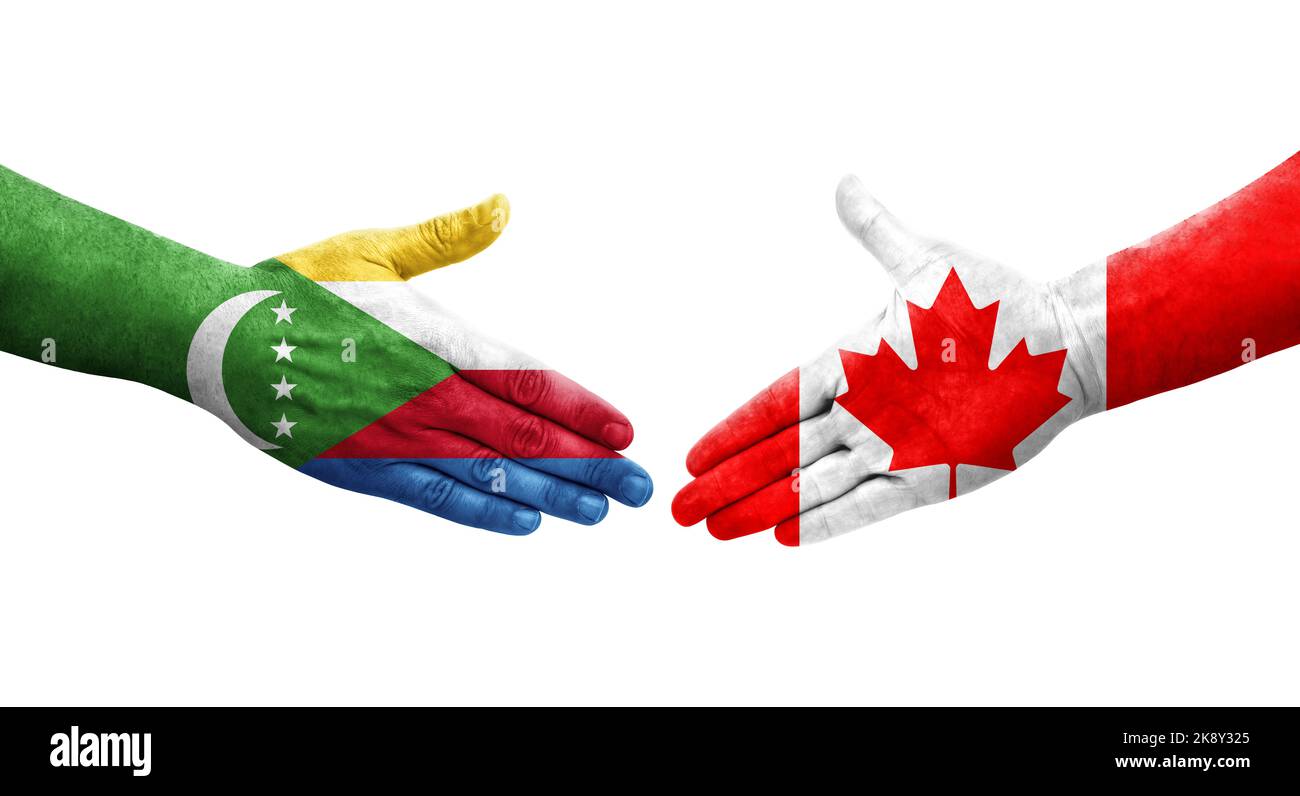 Handshake between Canada and Comoros flags painted on hands, isolated ...