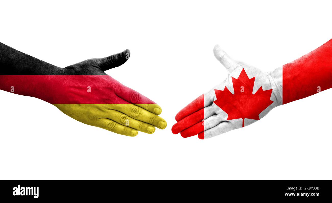 Handshake between Canada and Germany flags painted on hands, isolated ...