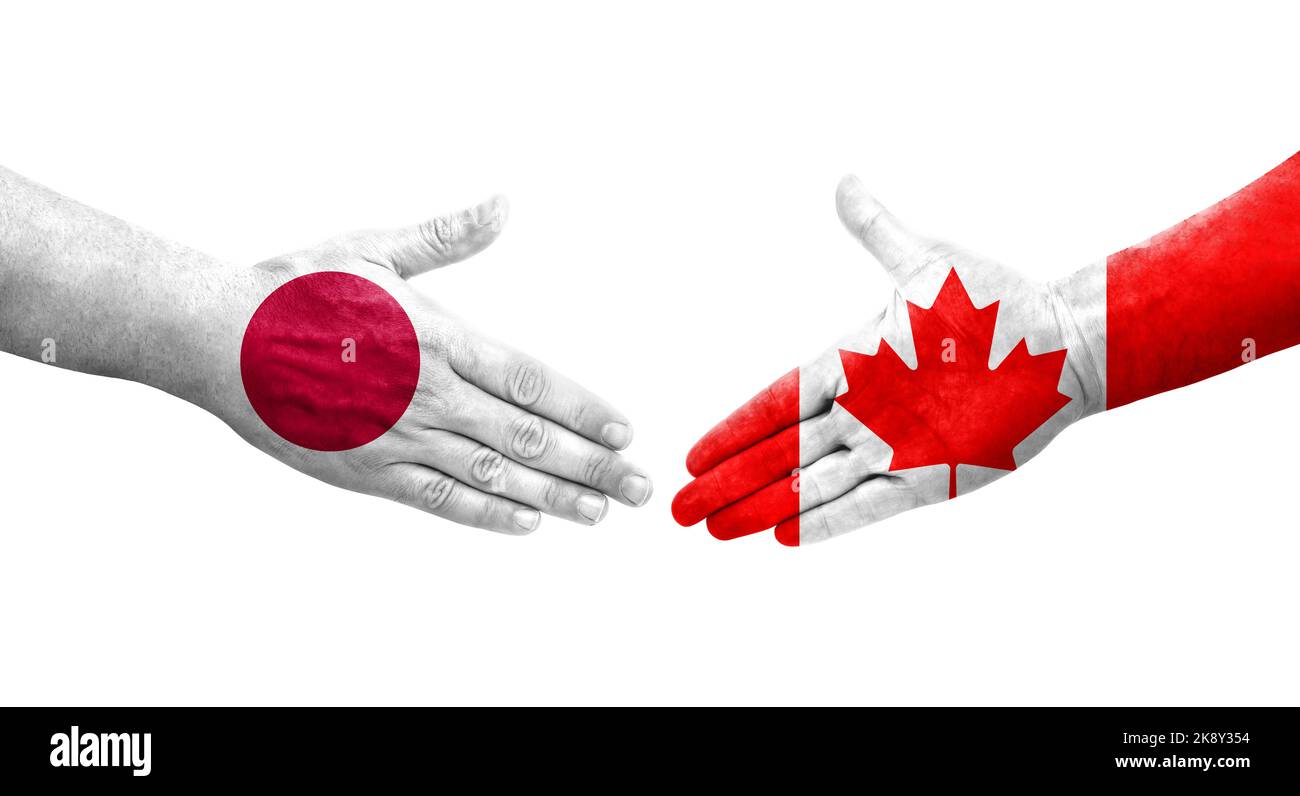Handshake between Canada and Japan flags painted on hands, isolated ...
