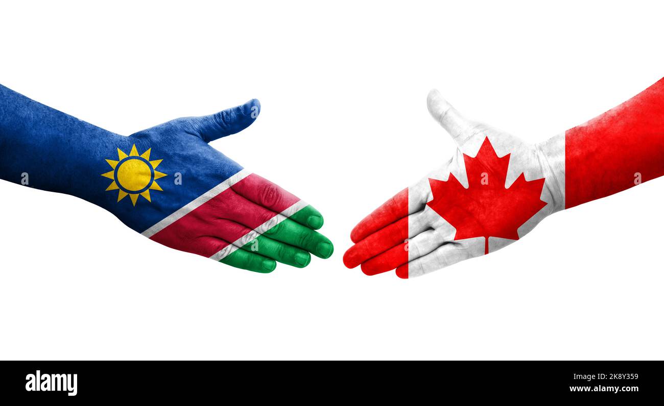 Handshake between Canada and Namibia flags painted on hands, isolated ...