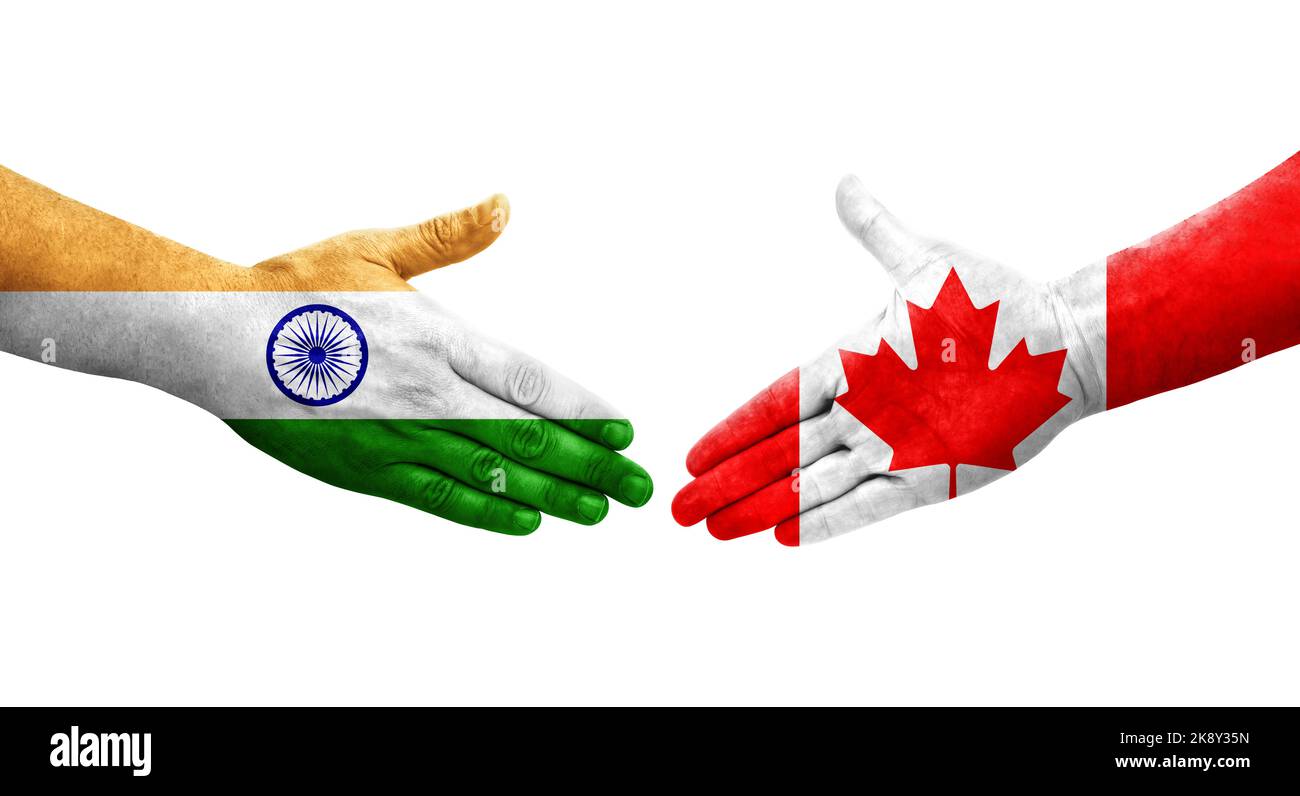 Handshake between Canada and India flags painted on hands, isolated ...