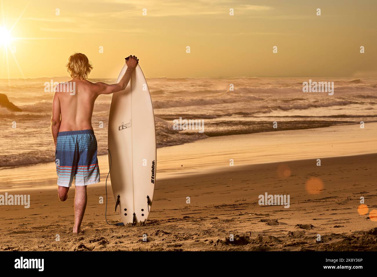 One legged disabled surfer on beach looking at waves Stock Photo - Alamy